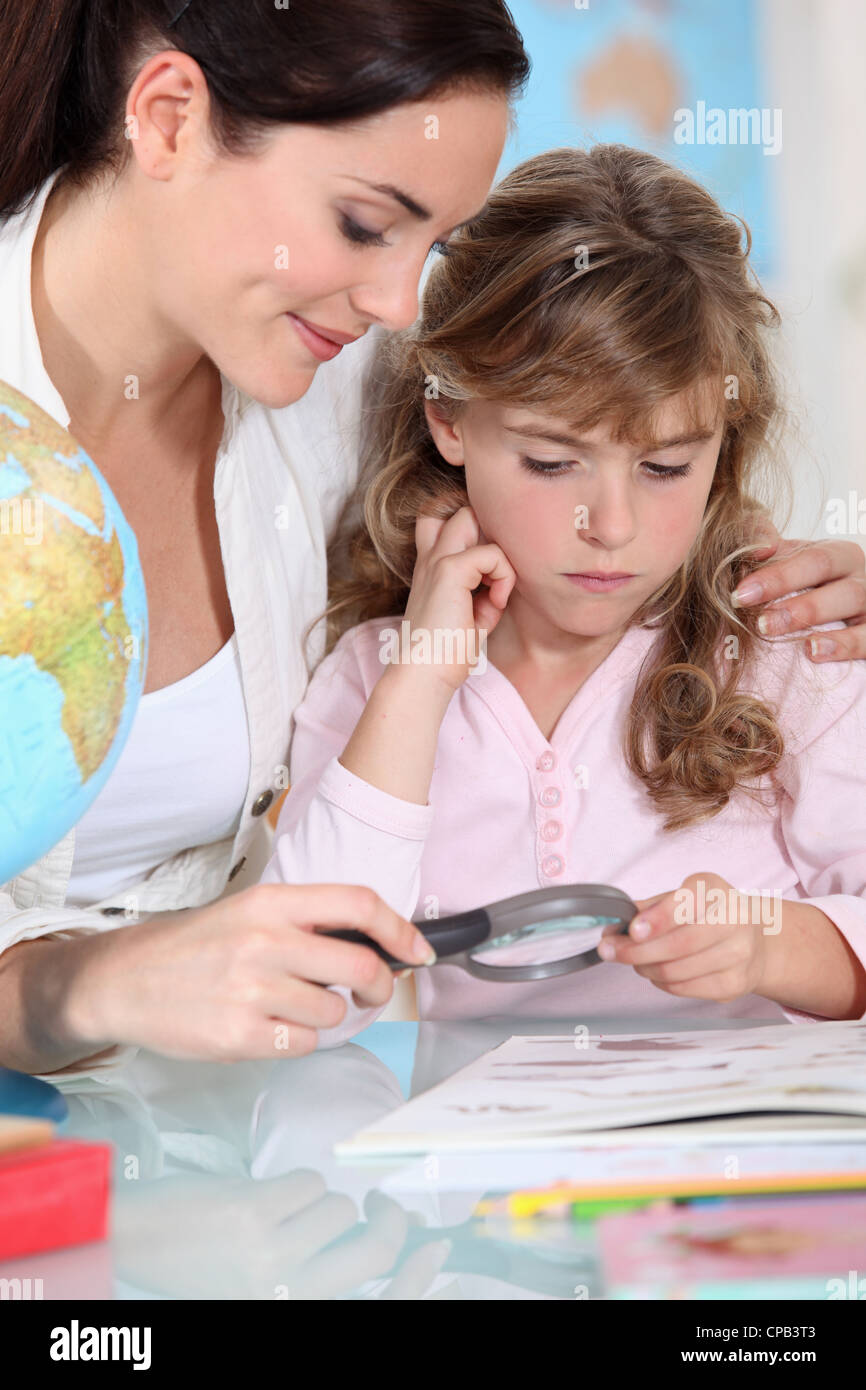 Mother teaching little girl Stock Photo - Alamy