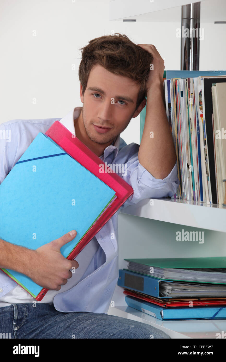Young man in a library Stock Photo - Alamy