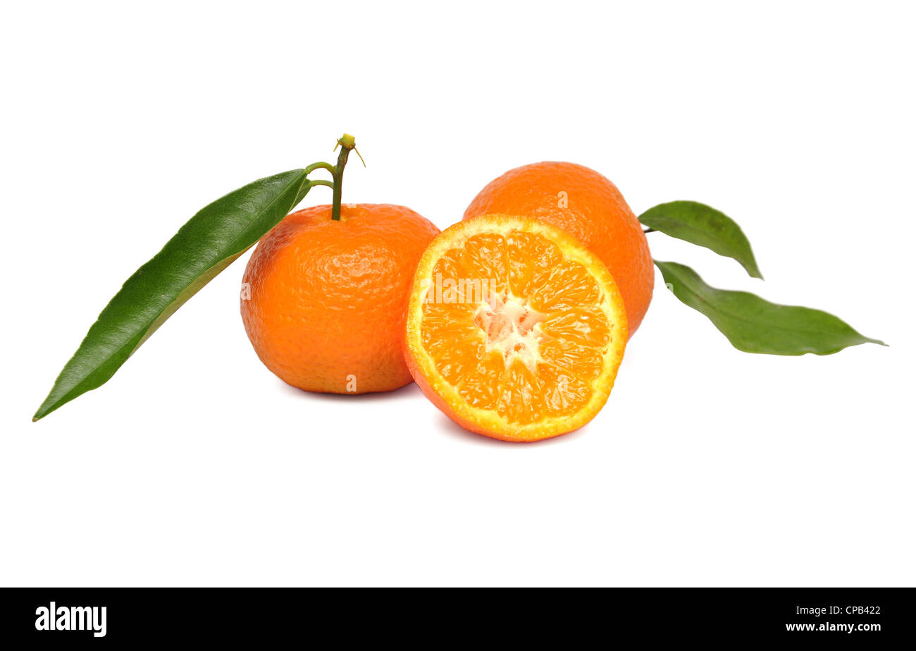 two mandarins with green leaves and half isolated on white background ...
