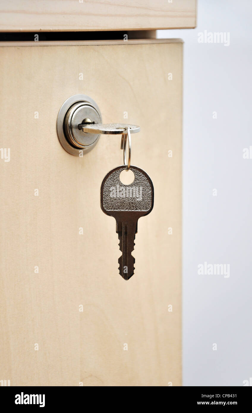 key in lock of wooden desk drawer, closeup Stock Photo - Alamy