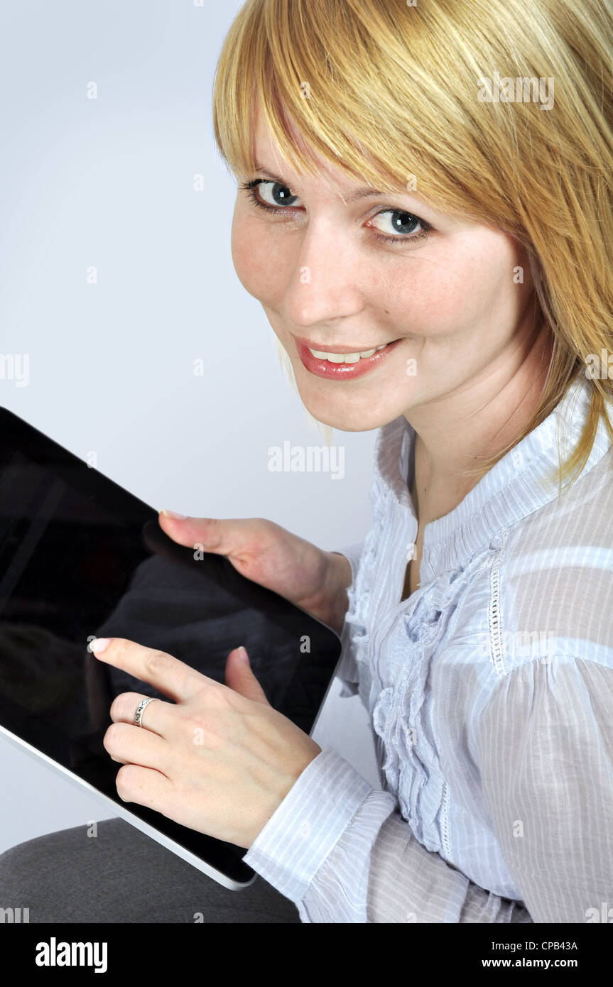 Young smiling woman using electronic tablet pc Stock Photo - Alamy