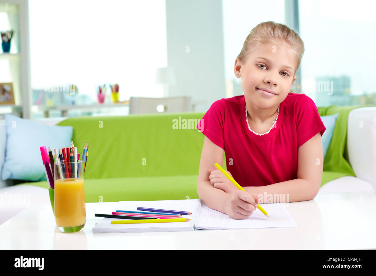 Portrait of lovely girl drawing with colorful pencils Stock Photo - Alamy