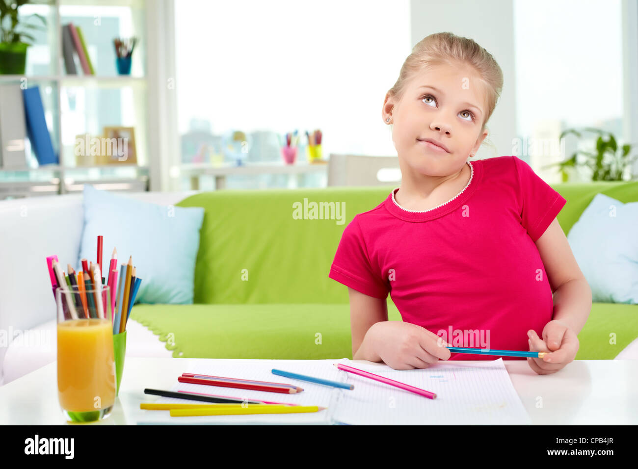 Portrait of pensive girl drawing with colorful pencils Stock Photo - Alamy