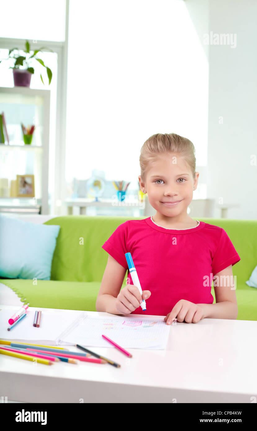Lovely girl looking at camera while drawing with colorful pencils Stock ...