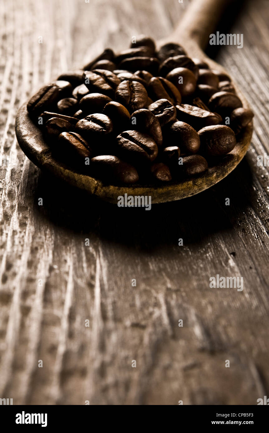 roasted coffee beans and wood spoon Stock Photo - Alamy