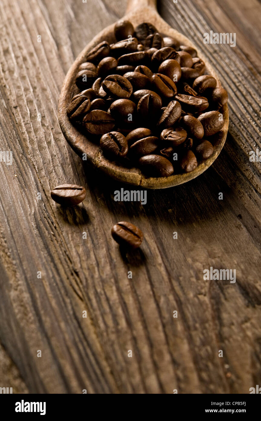 roasted coffee beans and wood spoon Stock Photo - Alamy