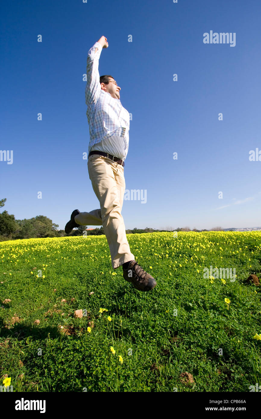a young man jumping high to sucess Stock Photo - Alamy