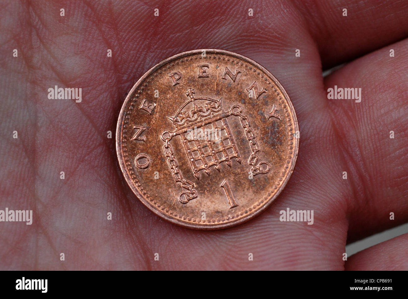 One Pence Coin in Palm of Hand Stock Photo - Alamy