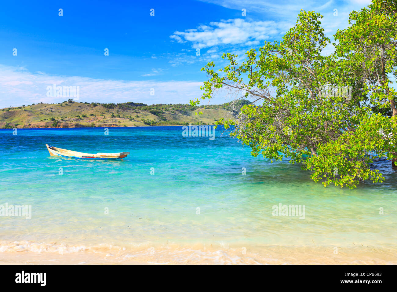 Tropical island landscape. Boat on the foreground Stock Photo - Alamy