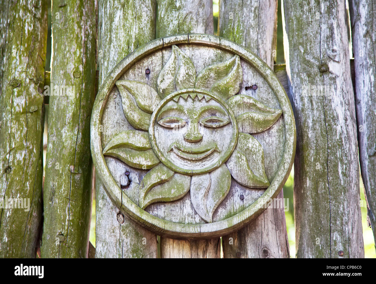 Pagan wooden sun sign on a log Stock Photo - Alamy