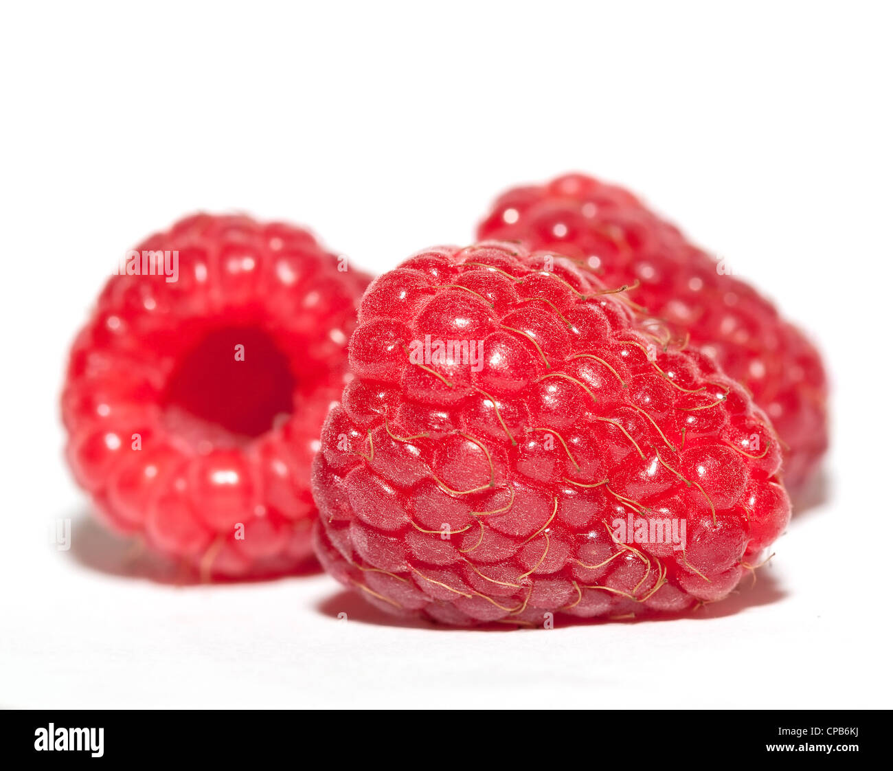Raspberries on white background Stock Photo - Alamy