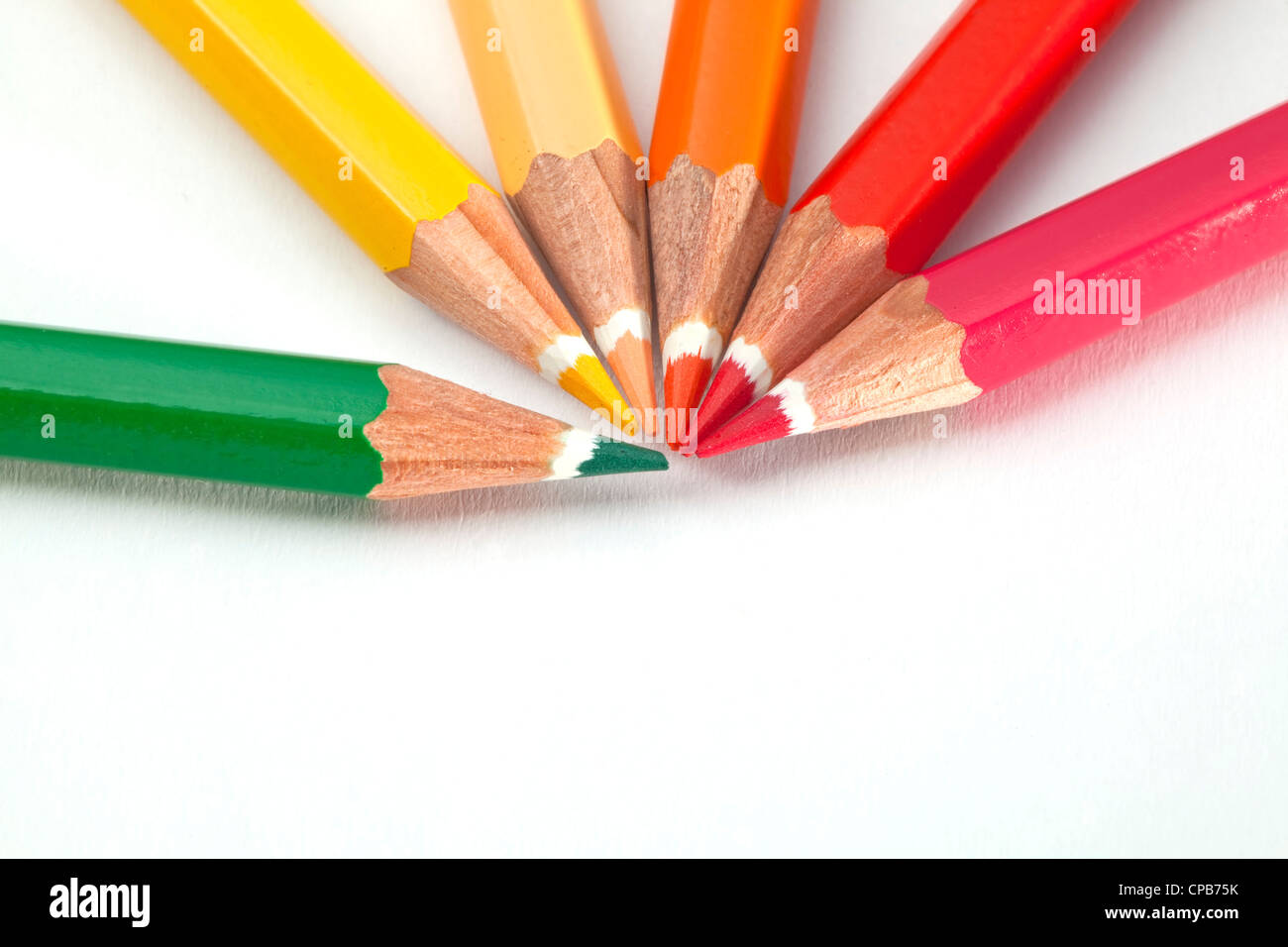 Many colored pencils on the white paper background Stock Photo - Alamy