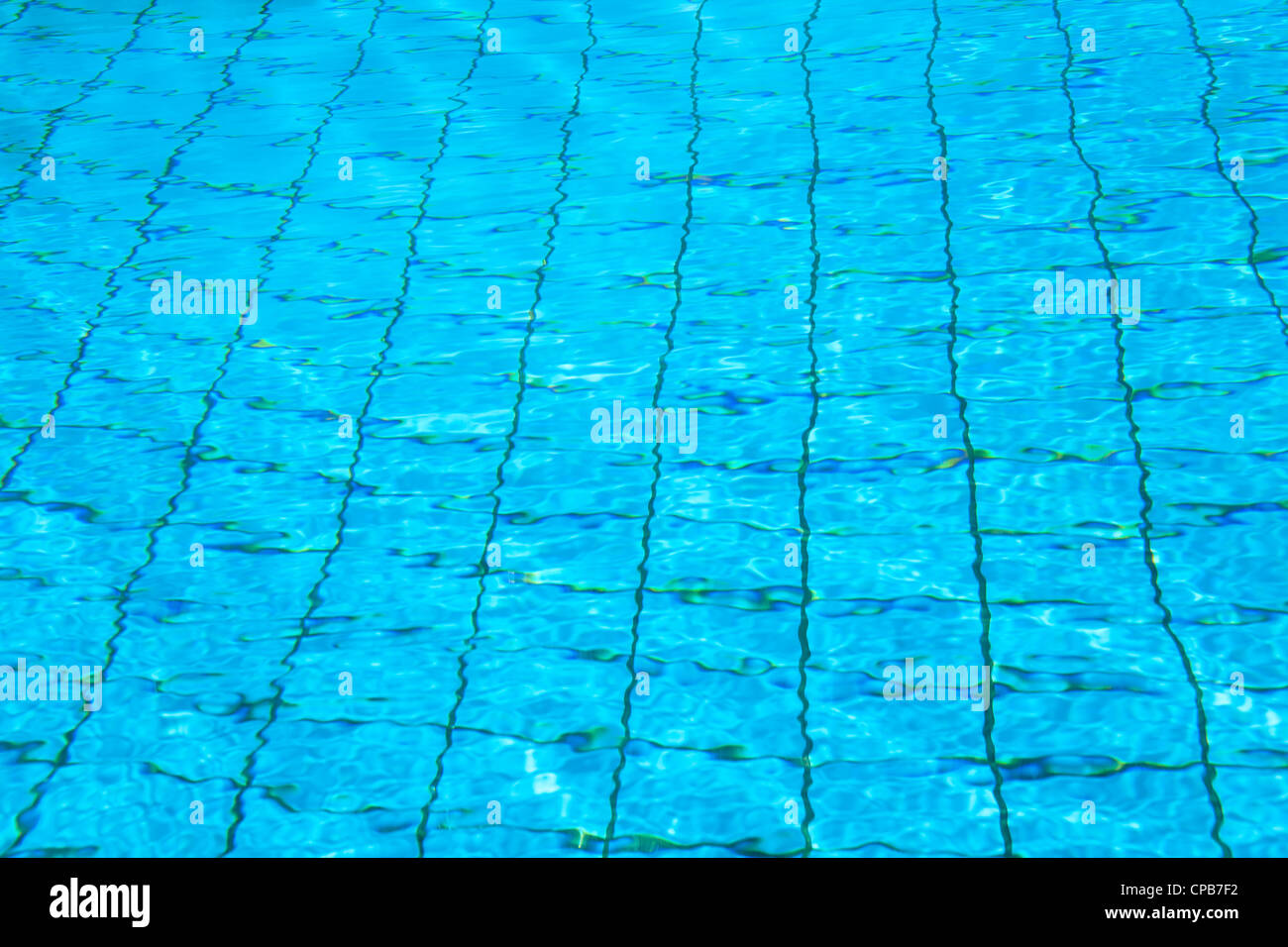 Patterns of sunlight rippling on a swimming pool water surface Stock ...