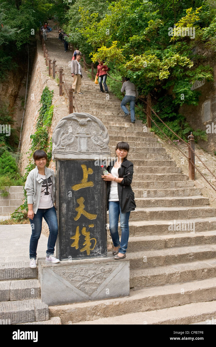 2 Chinese girls pose for the camera and showing the steep steps leading ...