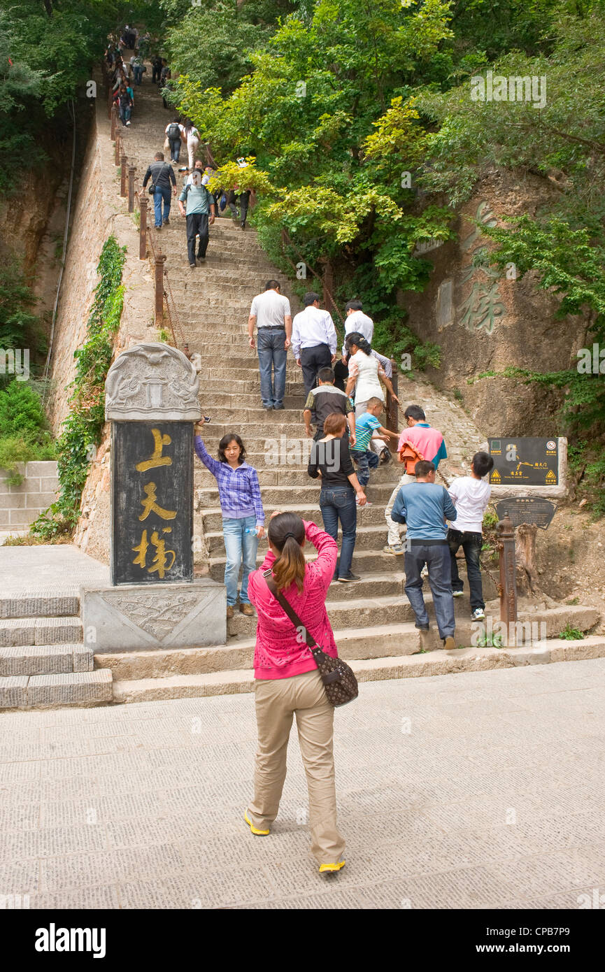 Chinese tourists pose for the camera and showing the steep steps ...