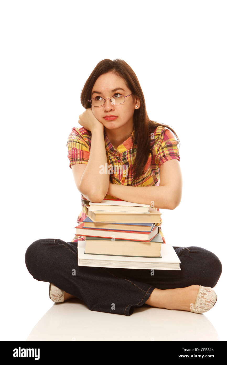 Pretty coed thinking with a pile of books on white background. ("Coed ...