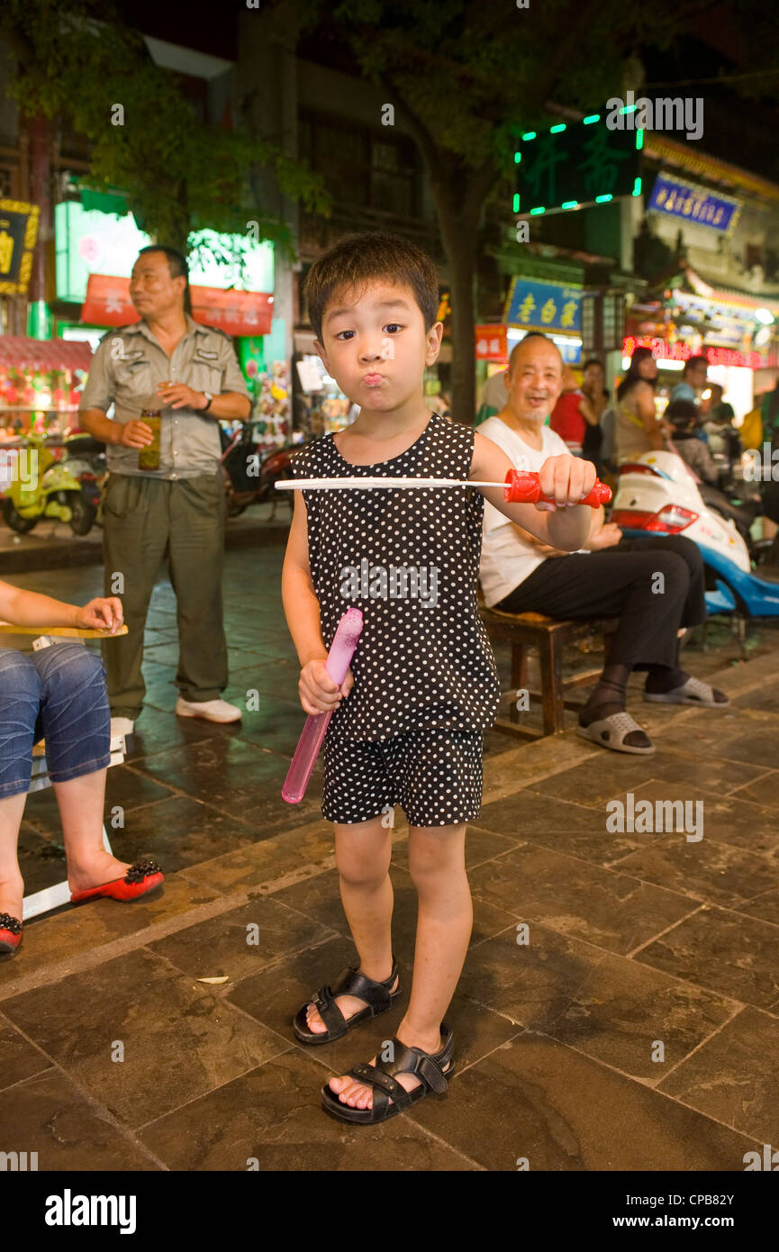 A cute young Chinese boy poses for the camera at Moslem Street (Huimin ...