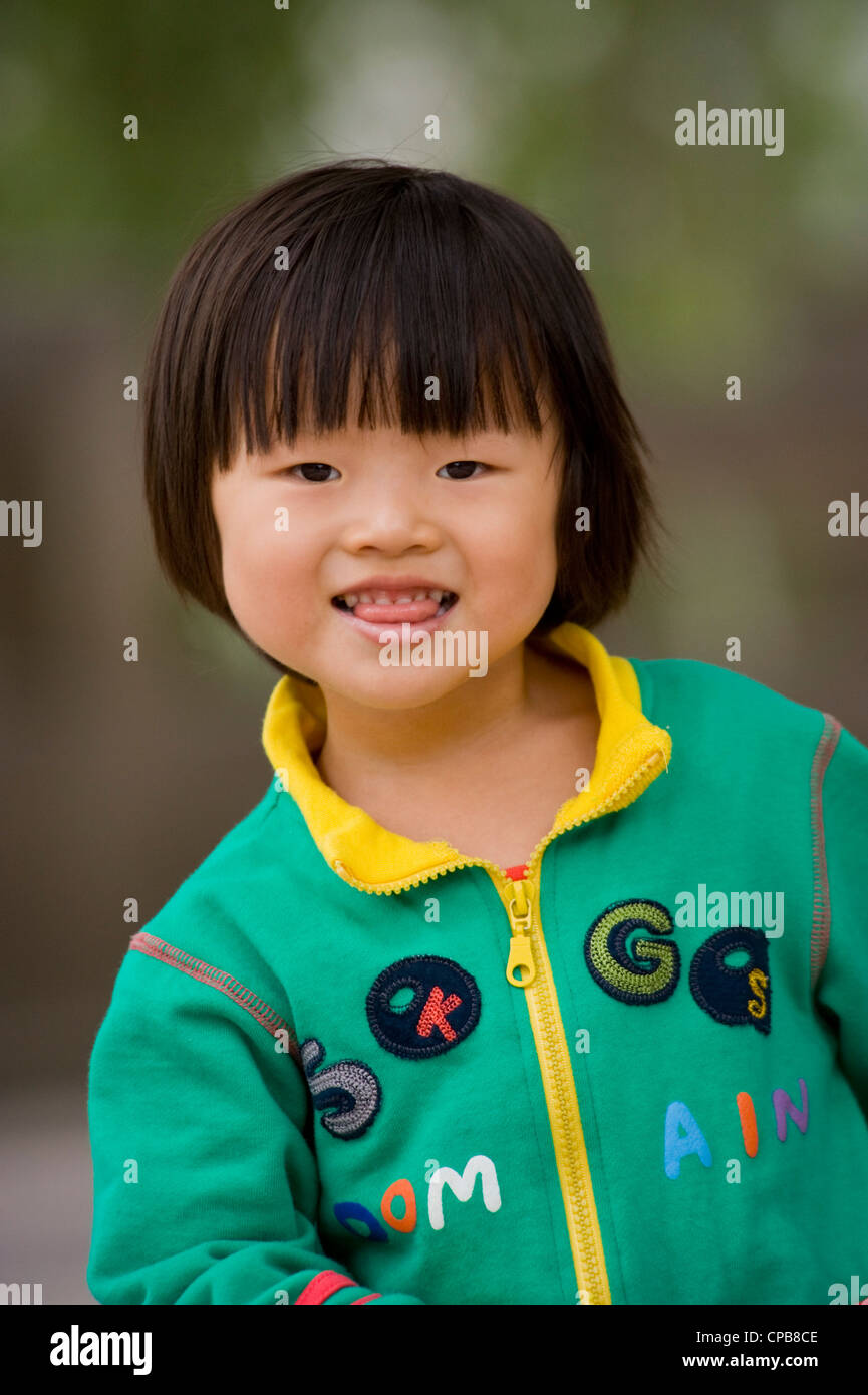 A cute young chinese girl poses and smiles for the camera Stock Photo ...