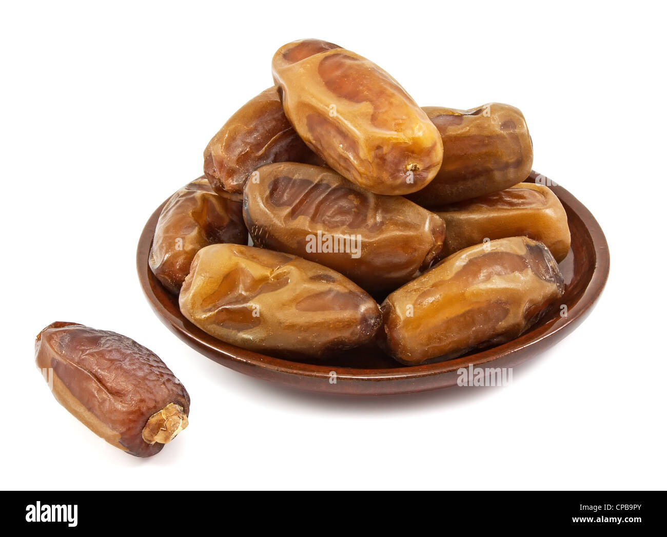 date fruits in a plate on white background Stock Photo - Alamy