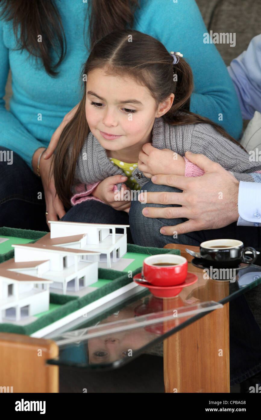 Girl looking at scale model of future home Stock Photo - Alamy