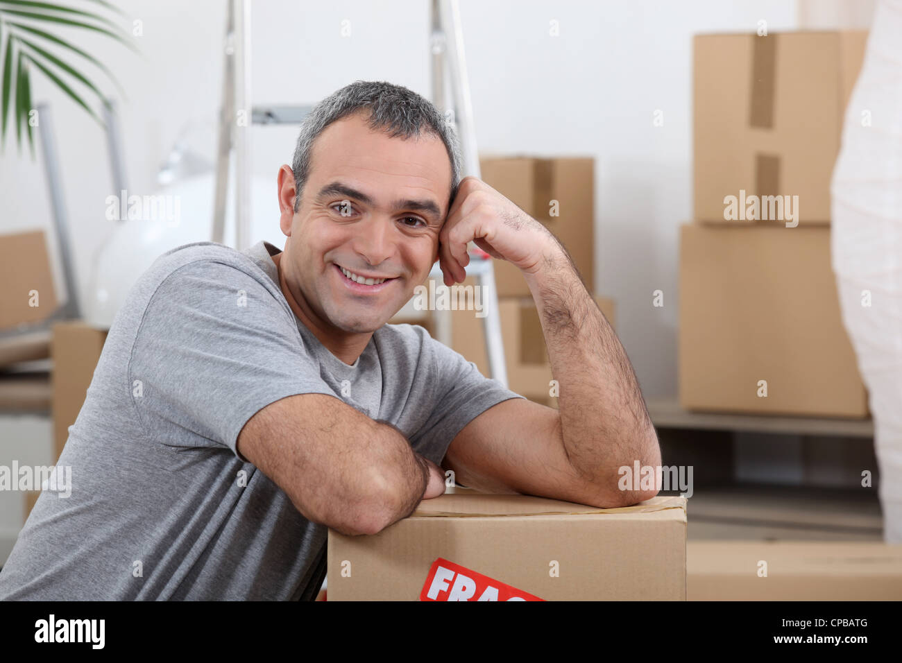 Man with moving cartons Stock Photo - Alamy