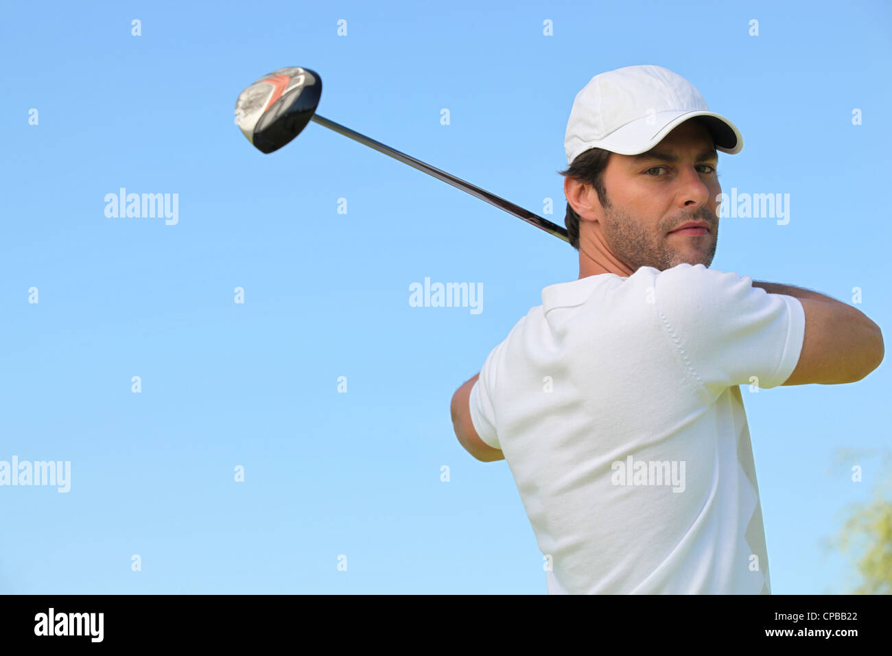 Golfer taking a swing Stock Photo - Alamy
