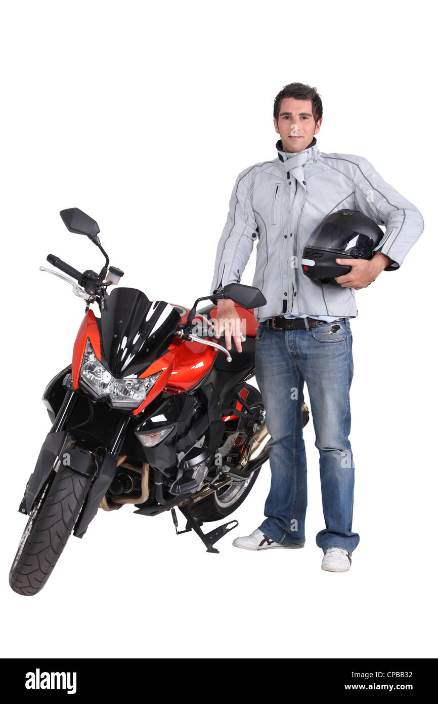 Motorcyclist with his motorbike Stock Photo - Alamy