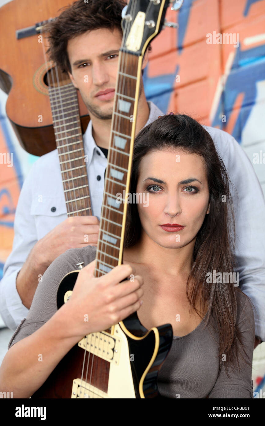 young woman and man playing in a music band Stock Photo - Alamy