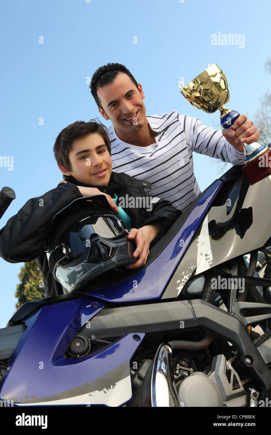 Father and son holding a trophy Stock Photo - Alamy