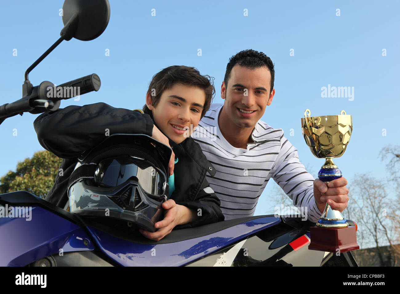 boy winning a motorcycle racing cup Stock Photo - Alamy