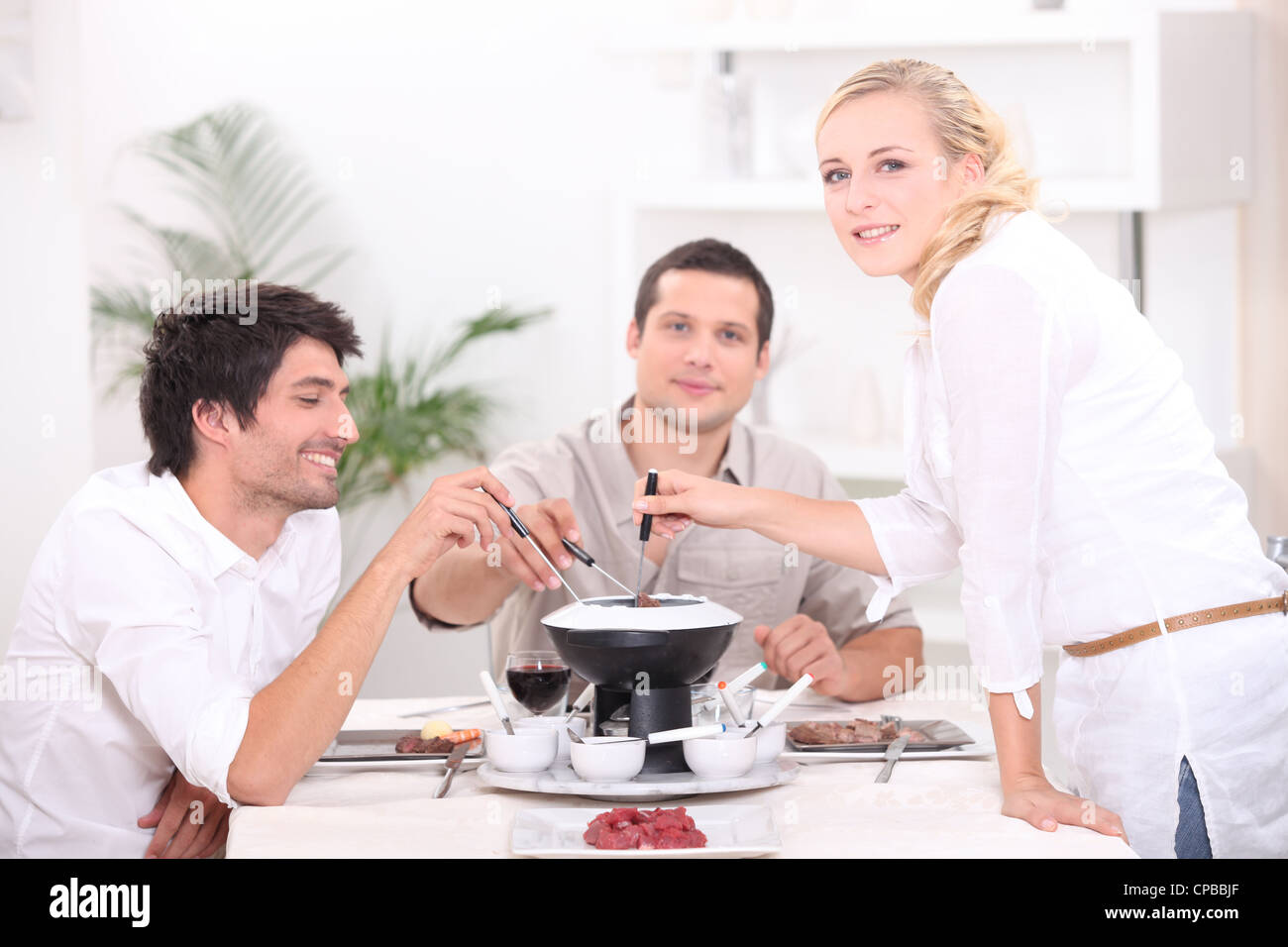 friends at table Stock Photo - Alamy