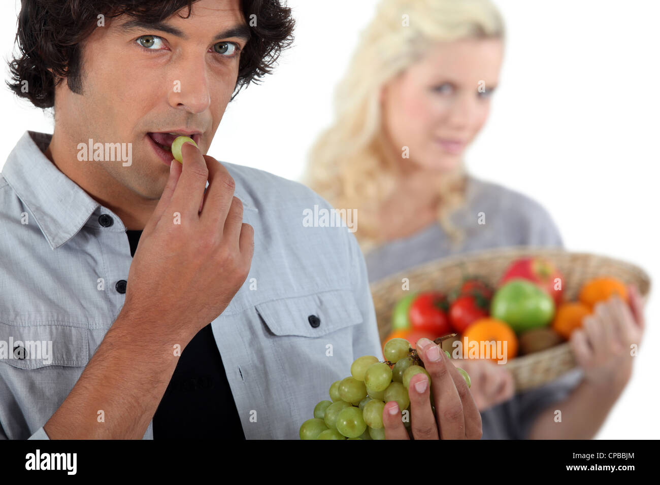 Couple eating fruit Stock Photo - Alamy