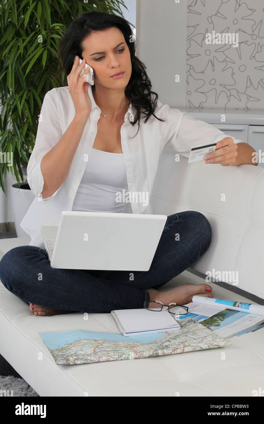 Woman booking her holiday on-line Stock Photo - Alamy