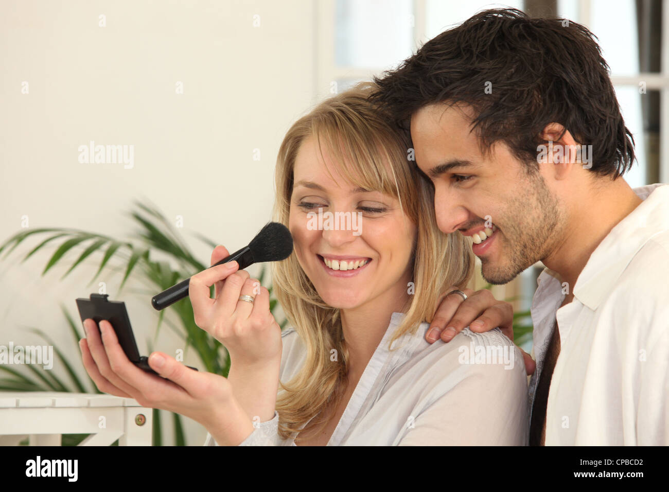 Man watching woman applying makeup Stock Photo - Alamy