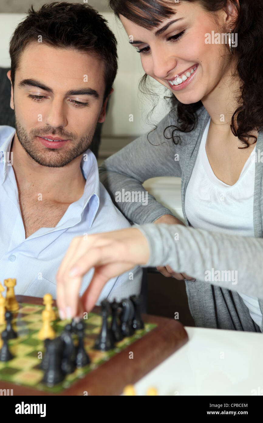 Couple playing chess Stock Photo - Alamy