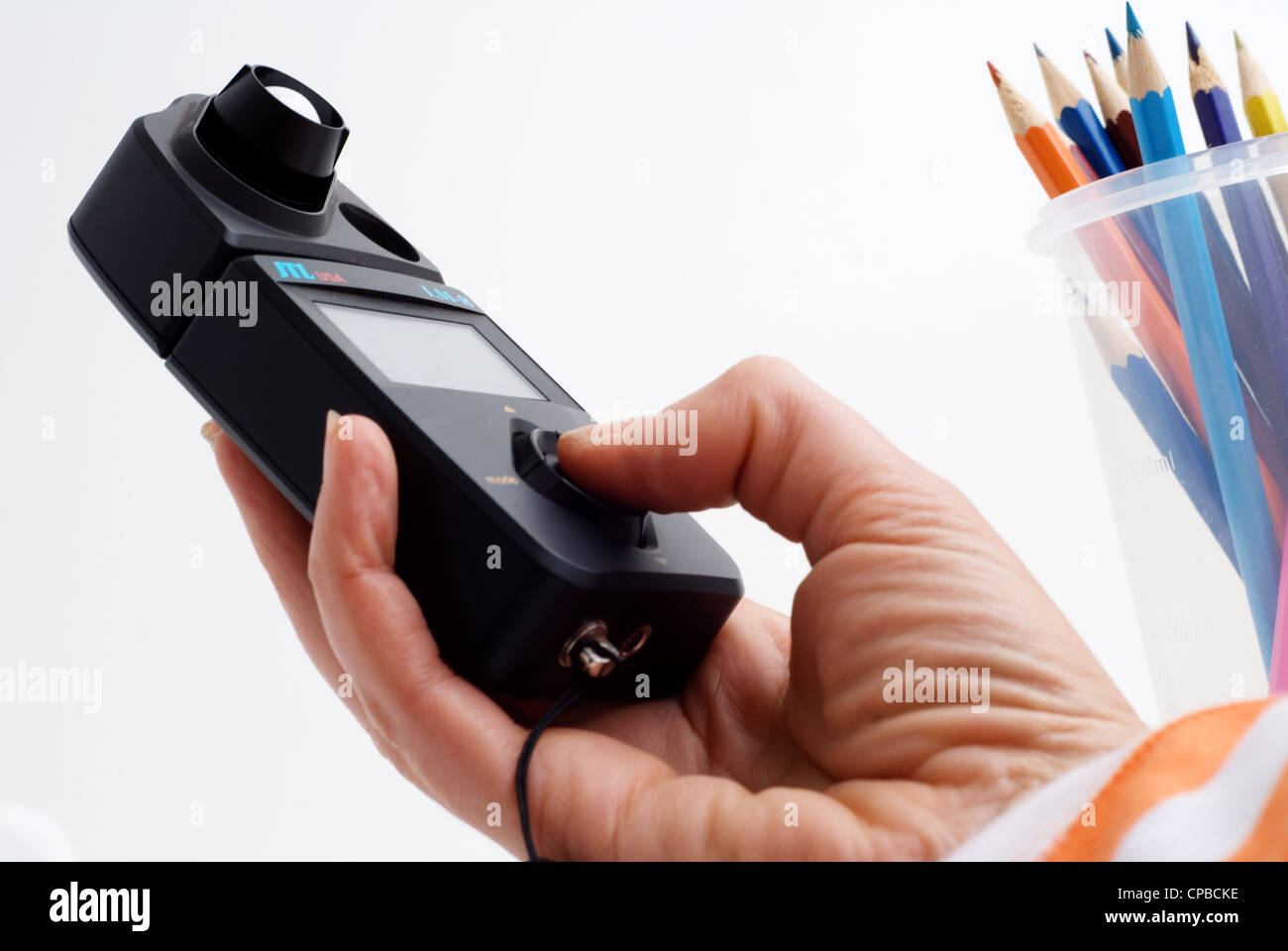 Photographic light meter taking measurement for photo shoot Stock Photo ...