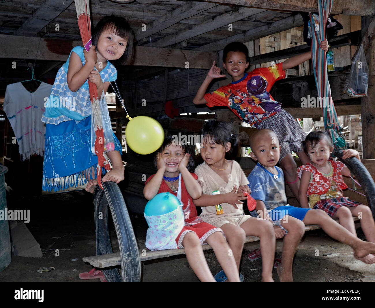 Group of fun loving Thai children on a makeshift swing. Thailand rural ...