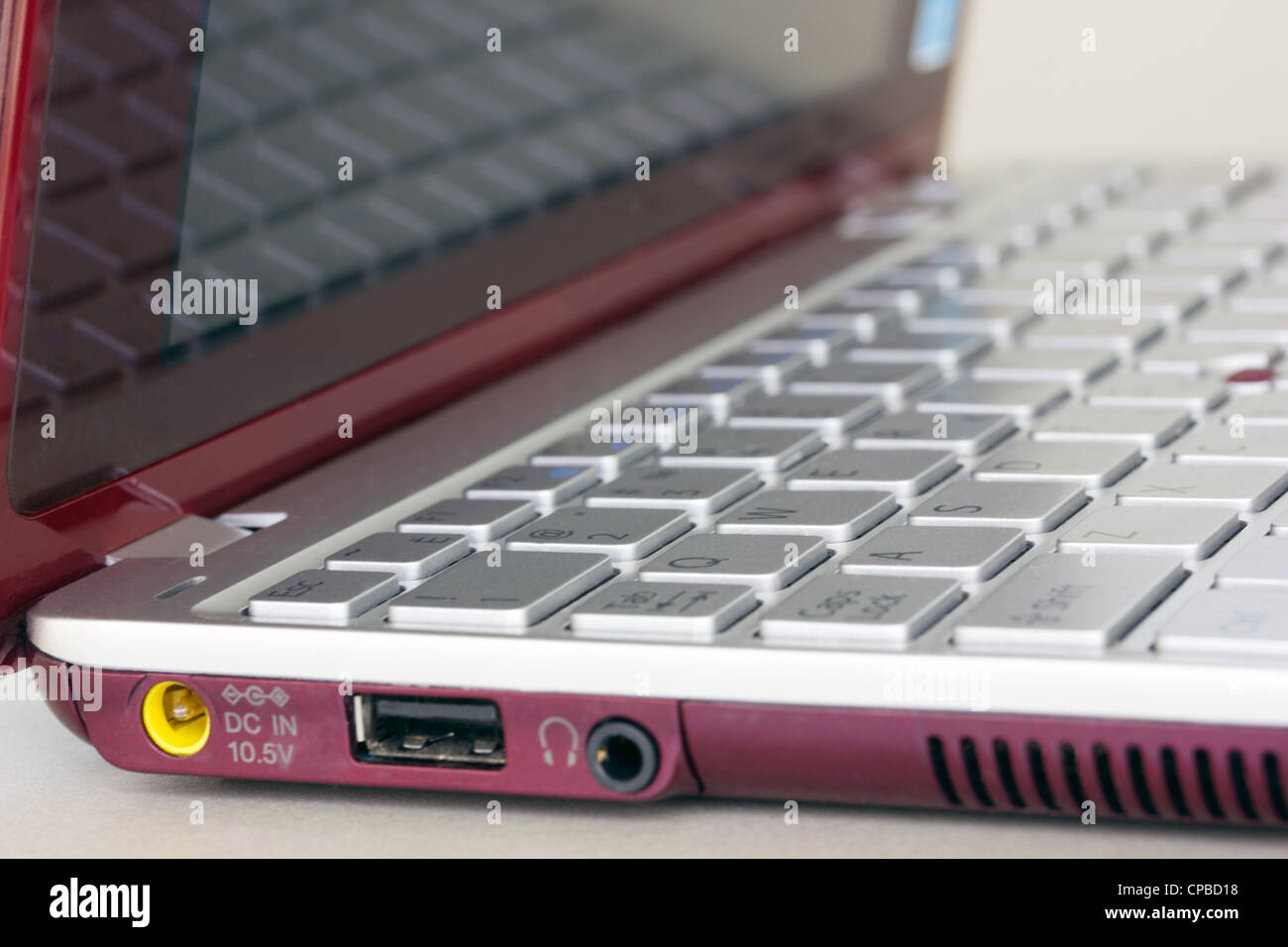 modern red small netbook with gray keyboard Stock Photo - Alamy