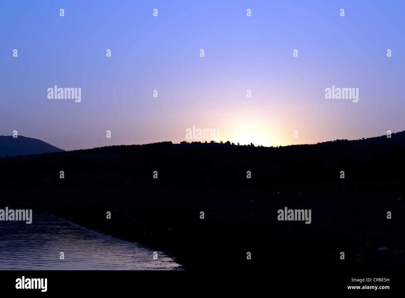 Morning lake landscape with sunrise over mountains Stock Photo - Alamy