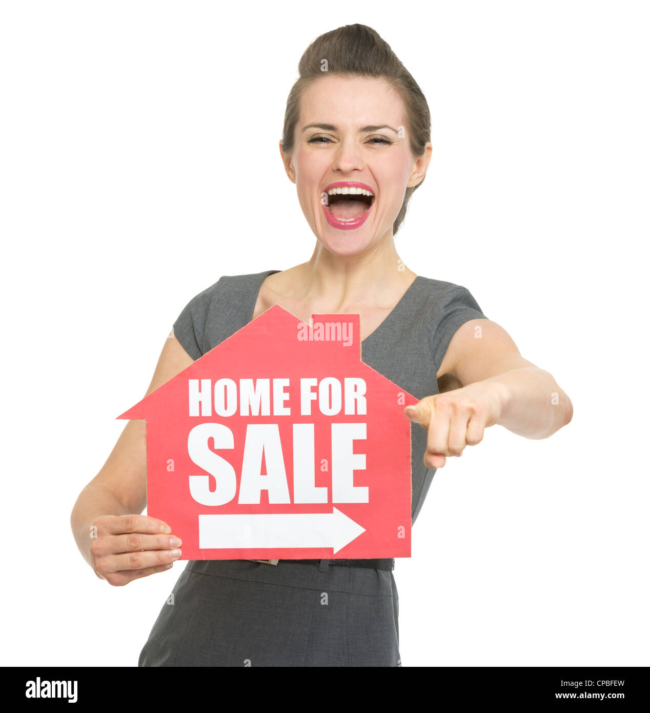 Smiling realtor showing home for sale sign and pointing on you Stock ...