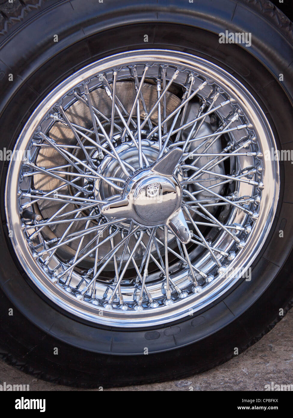 Polished chrome spokes on a vintage car tyre Stock Photo - Alamy