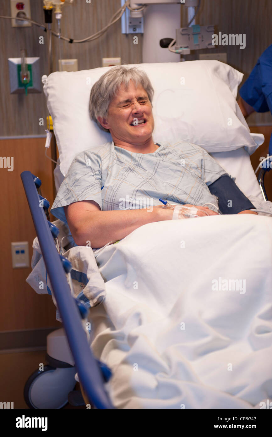 Female patient expressing distress in hospital bed Stock Photo - Alamy