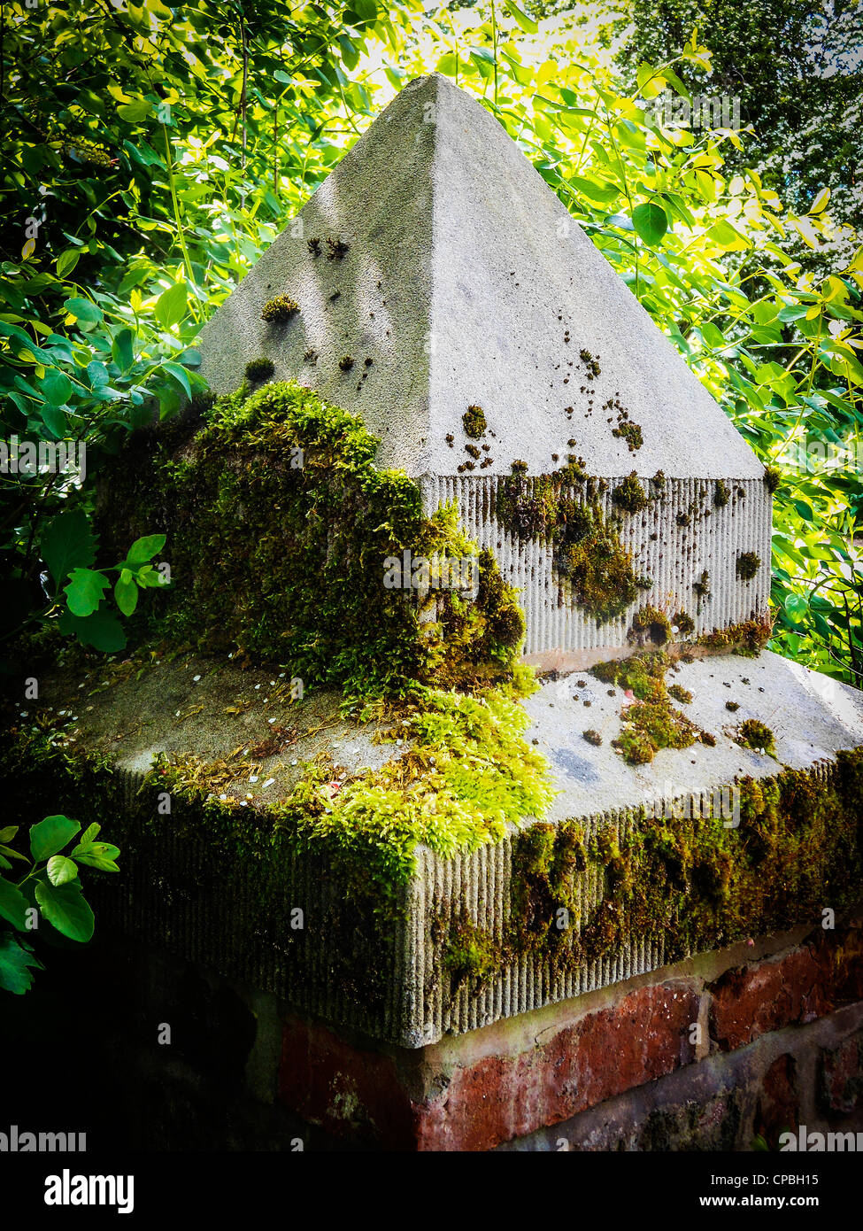 Pyramid topped, moss-covered corner column to a garden wall Stock Photo ...