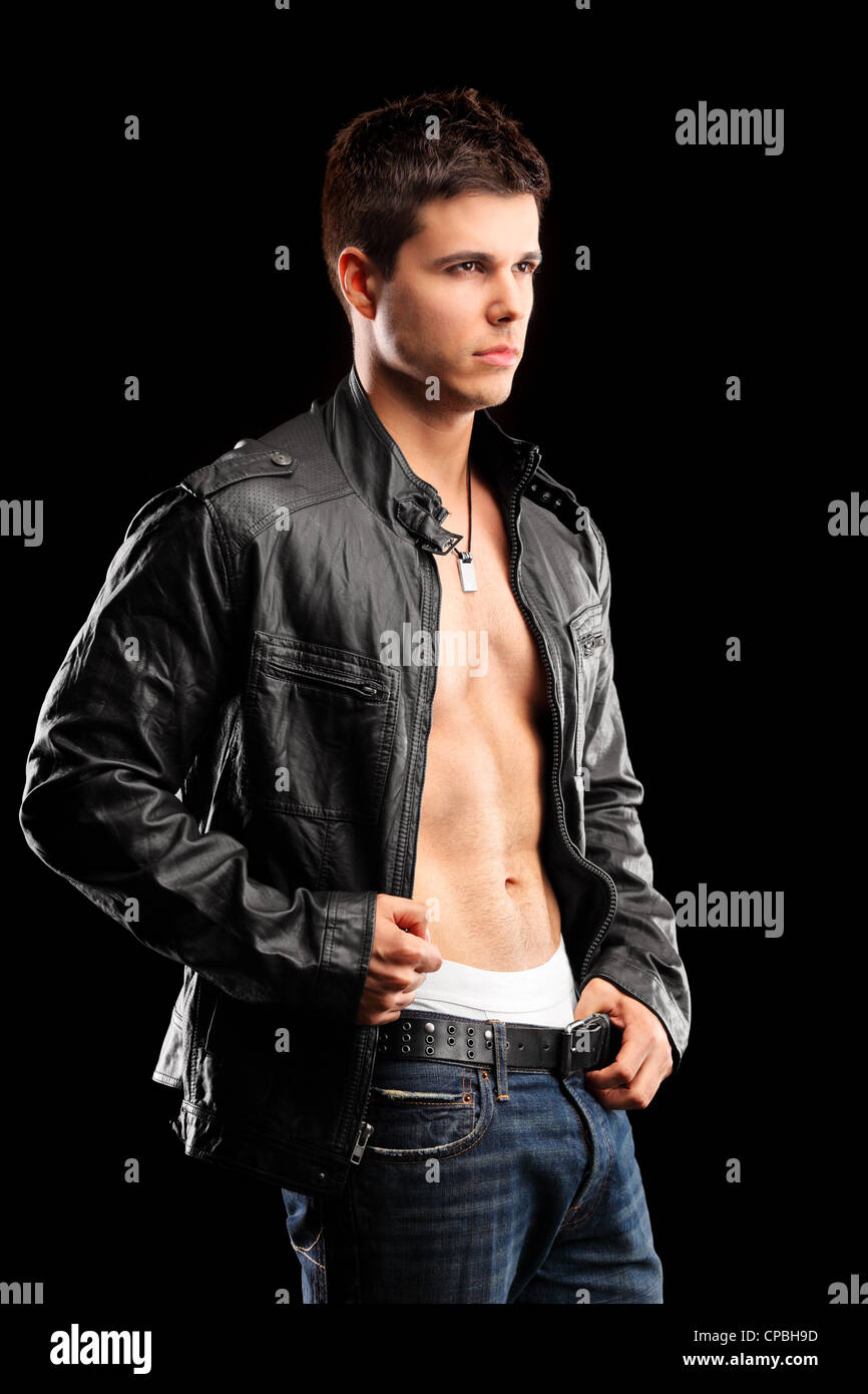 A portrait of a male model posing isolated against black background ...