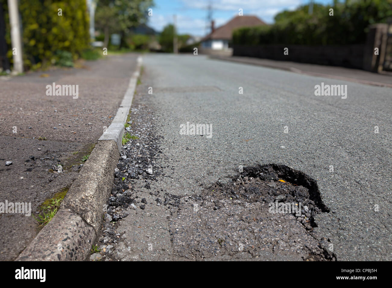 Pothole in road requiring repair, Llanfoist village, Wales, UK Stock ...