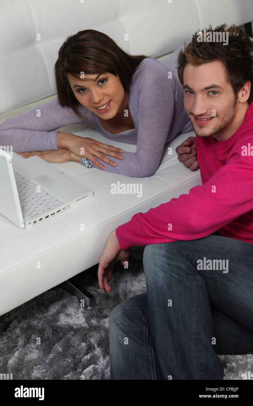 Couple using their wireless home network Stock Photo - Alamy
