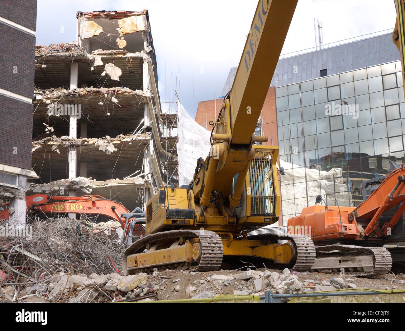 An old building being demolished by heavy machinery Stock Photo - Alamy