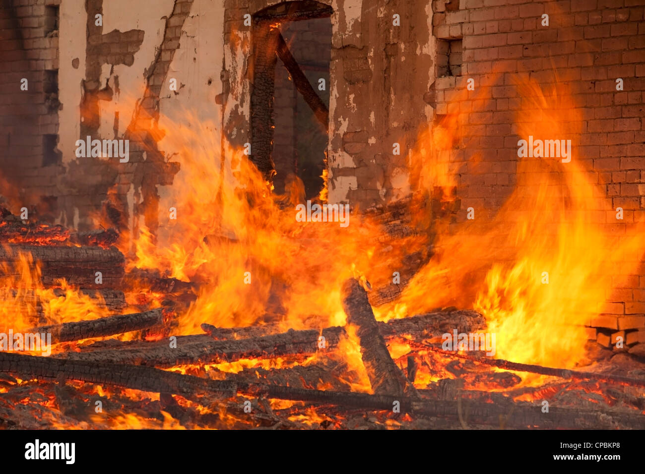 A building burning at night, showing flames and charred remains Stock ...