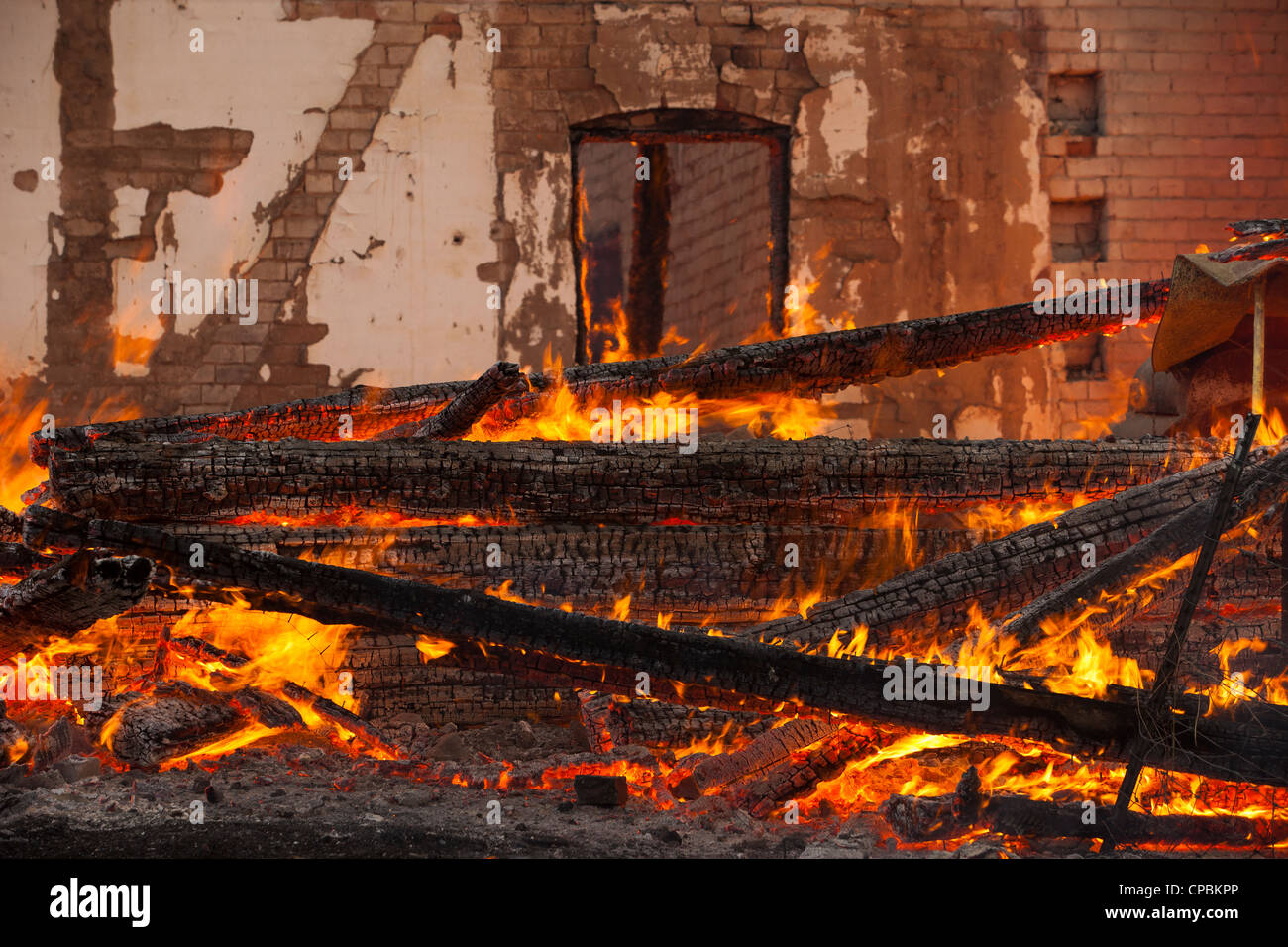 A building burning at night, showing flames and charred remains Stock ...