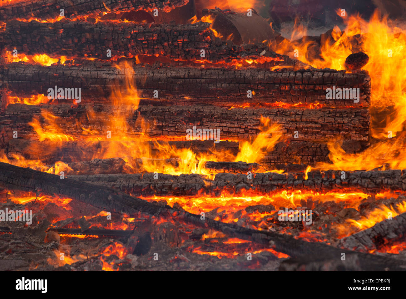 A building burning at night, close up of flames and charred remains ...